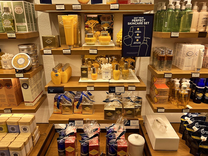 L'Occitane's golden treasures arranged like artifacts in a museum of self-care, tempting visitors with the promise of French luxury.