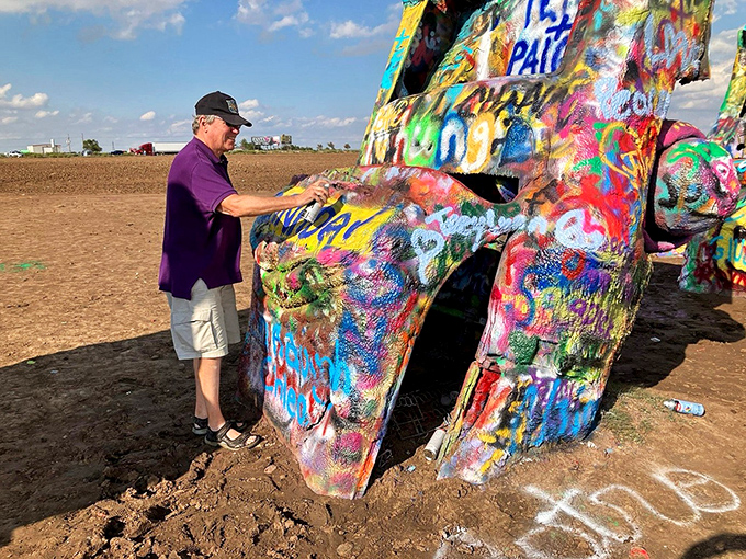 "Just a little touch-up!" Visitors of all ages embrace the chance to leave their mark, even if it only lasts until the next artist arrives.