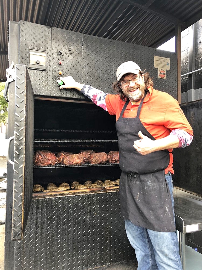 Behind every great barbecue joint is someone who doesn't mind smelling like smoke for the rest of their life. The thumbs-up says it all.