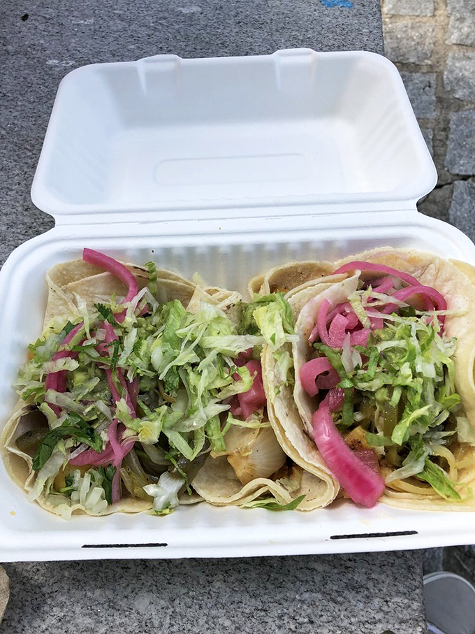 Tacos adorned with pickled onions so vibrant they could stop traffic. These aren't just garnishes—they're edible jewelry for your lunch.