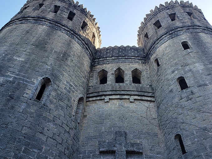 The castle's distinctive turrets reach skyward, their rough-hewn stones capturing the essence of medieval construction with Florida materials.