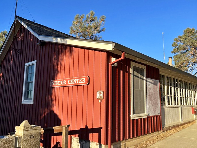 The red visitor center stands as a cheerful basecamp for adventures, like the friendly neighbor who always has the best trail advice.