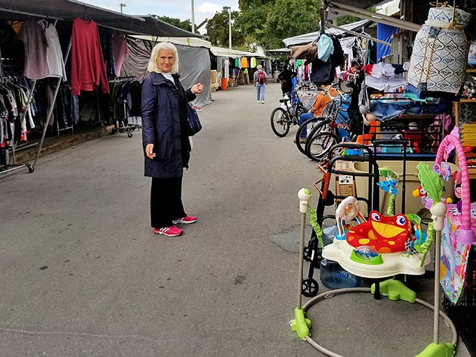 Clothing racks and everyday finds line this outdoor aisle where bargain hunting feels wonderfully unpredictable.