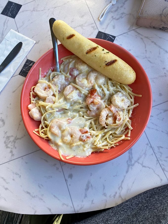 Pasta Alfredo with shrimp that would make an Italian grandmother nod in approval. The garlic bread isn't just a side &ndash; it's an essential tool.
