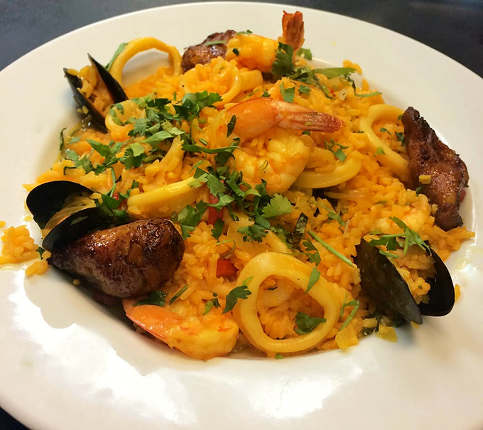 Paella's seafood-loving cousin arrives in a riot of saffron-tinged rice, shrimp, mussels and calamari—ocean bounty in every forkful.