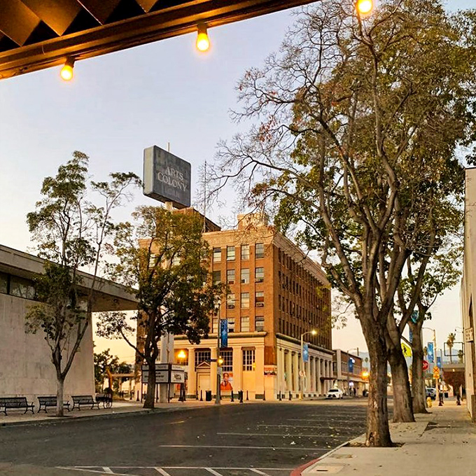 Dusk settles over Pomona's Arts Colony district, where historic buildings glow with warm light and promise evening explorations of culture and cuisine.