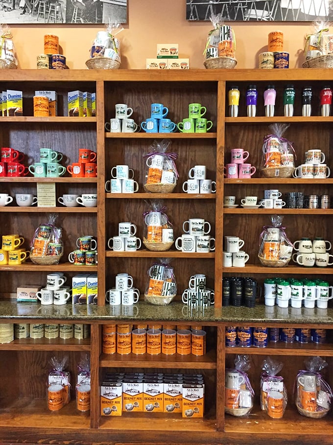 The merchandise wall tempts you to bring the experience home. Though homemade beignets never quite capture the magic, these mugs help you pretend.