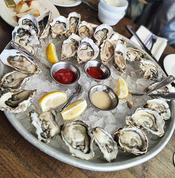 Nature's perfect appetizer, arranged like jewelry. These oysters are wearing their best accessories&mdash;lemon and mignonette.