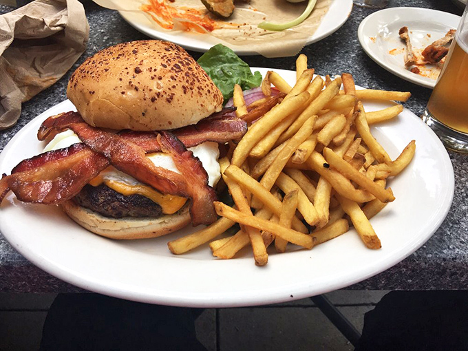 This isn't just a burger&mdash;it's architecture. The bacon forms perfect arches over melted cheese, creating a monument to American ingenuity.