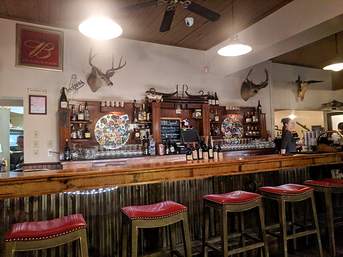 The bar area&mdash;where mounted deer heads remind you exactly what kind of place you're in. Hint: meat is taken seriously here.