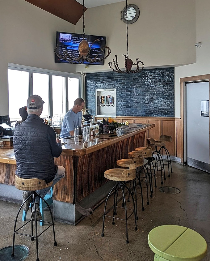 The bar area combines rustic wood and industrial elements, creating a space where fishermen and tech executives can equally feel at home.