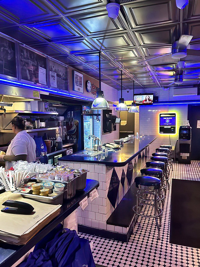 Blue neon lighting casts a dreamy glow across the counter, turning late-night hash brown cravings into a scene from an Edward Hopper painting.
