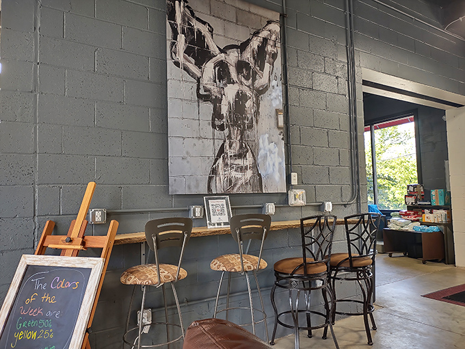 Industrial-chic seating area where shoppers contemplate their finds under artwork that wouldn't look out of place in a downtown gallery.
