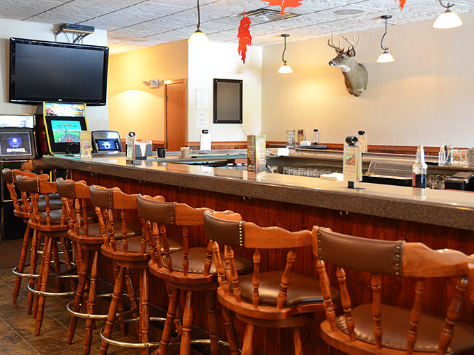 Bar stools that have supported countless elbows and hunting stories, beneath a mounted deer that's seen it all.