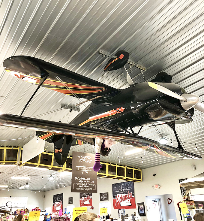 A vintage biplane soars overhead, adding unexpected whimsy to your candy shopping adventure. Aviation meets confection in this unique ceiling display.