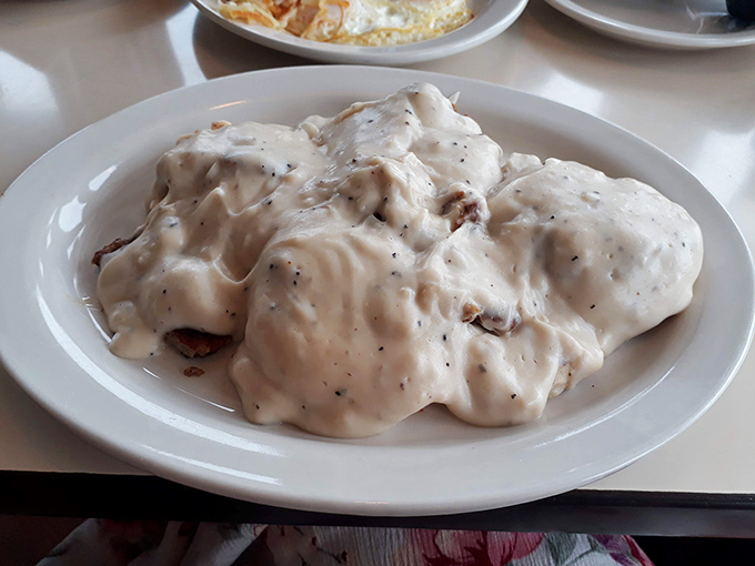Biscuits and gravy that would make your Southern grandmother nod with approval &ndash; a white sea of peppery comfort hiding treasure islands of savory sausage.