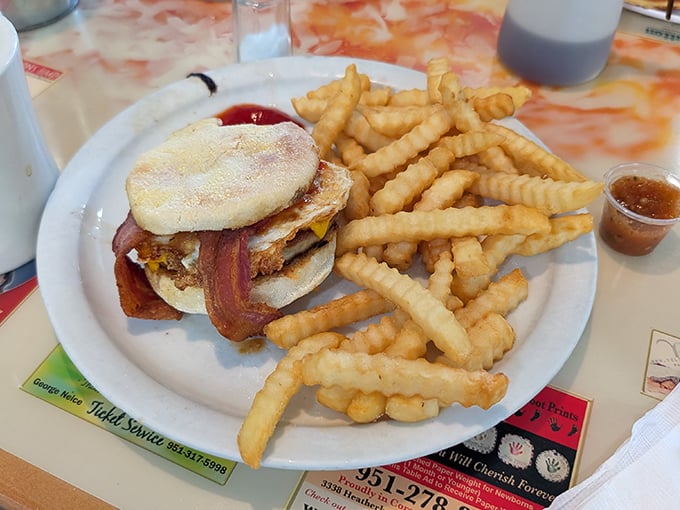 The breakfast sandwich that makes you question why anyone would ever choose a drive-thru version, flanked by fries that deserve their own fan club.