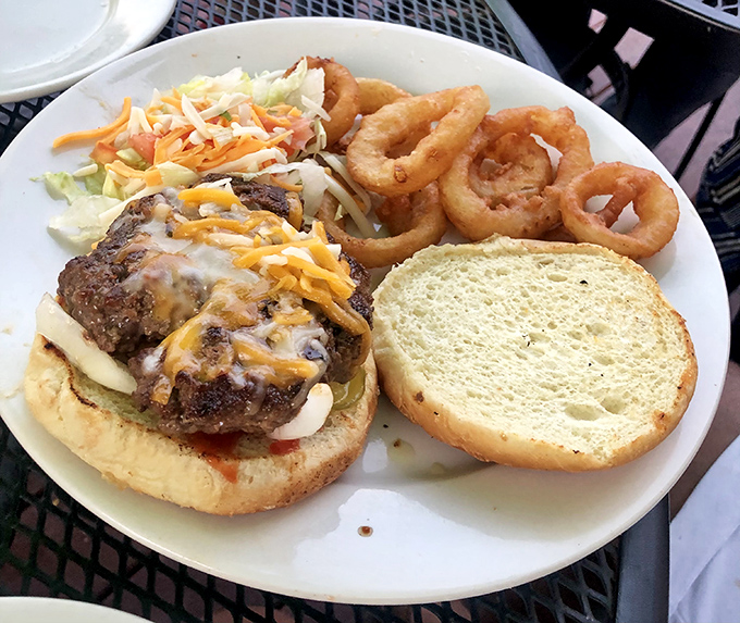 This isn't just a burger—it's a cross-cultural masterpiece topped with melted cheese and served with onion rings that deserve their own fan club.