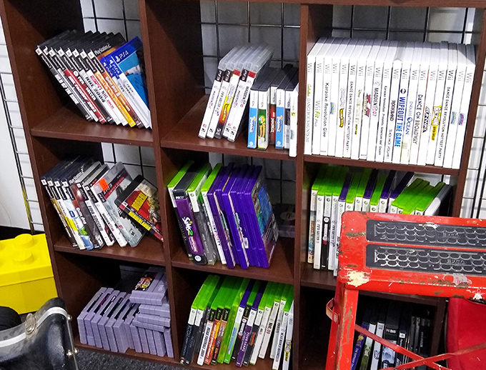 Video game nostalgia central! Those plastic cases hold digital worlds that defined childhoods and college dorm competitions across generations.