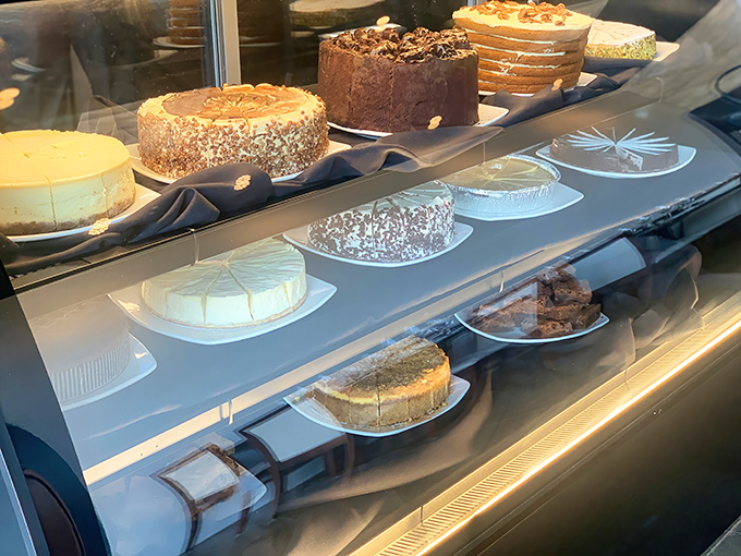 A dessert display that turns willpower into a laughable concept. Each cake looks like it should have its own Instagram account.