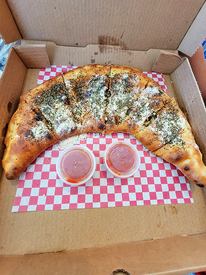 This calzone isn't just folded pizza&mdash;it's a self-contained flavor fortress with sauce sentries standing guard.