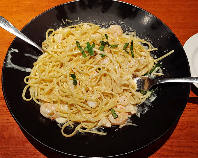 This pasta isn't just a dish; it's a relationship goal. Delicate strands coated just right, with shrimp playing hide and seek throughout.