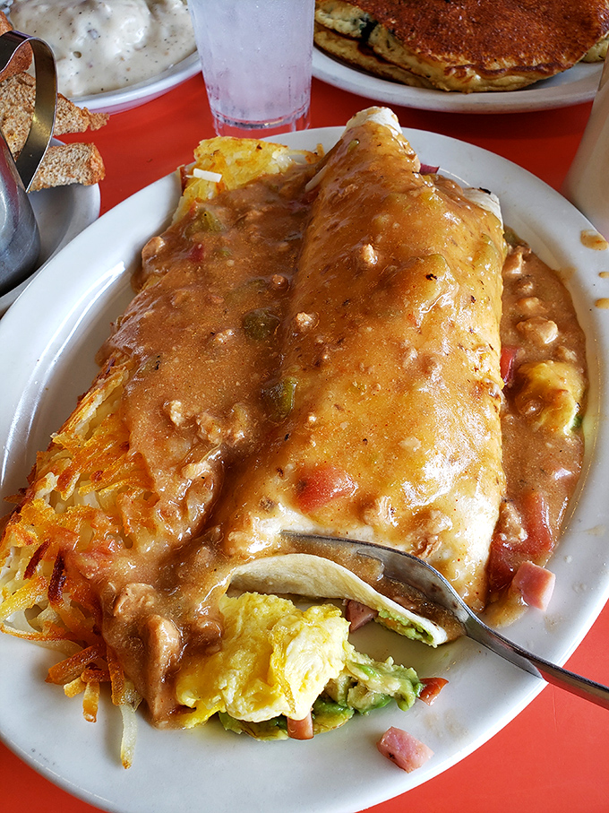 This burrito isn't just food, it's architecture &ndash; a structural marvel of eggs, cheese, and perfectly spiced meat under a blanket of sauce.
