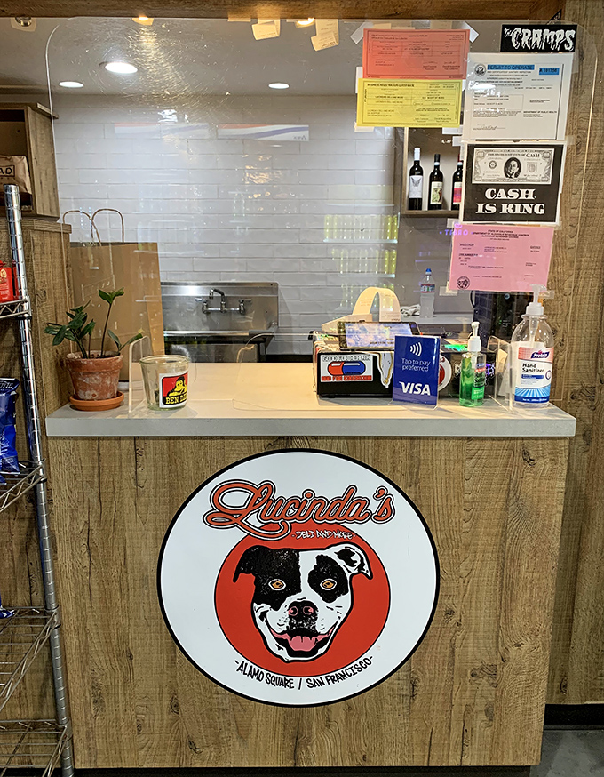 The counter tells the story&mdash;a smiling dog logo, cash-is-king sign, and plants that somehow survive in a sandwich shop. Character in every detail.