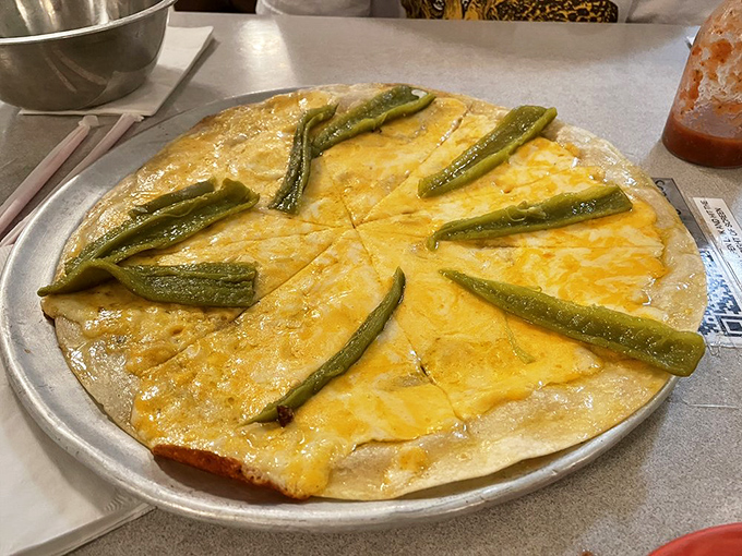 The cheese crisp—Arizona's answer to pizza—thin, crispy, and adorned with roasted green chiles that add just enough kick to keep things interesting.