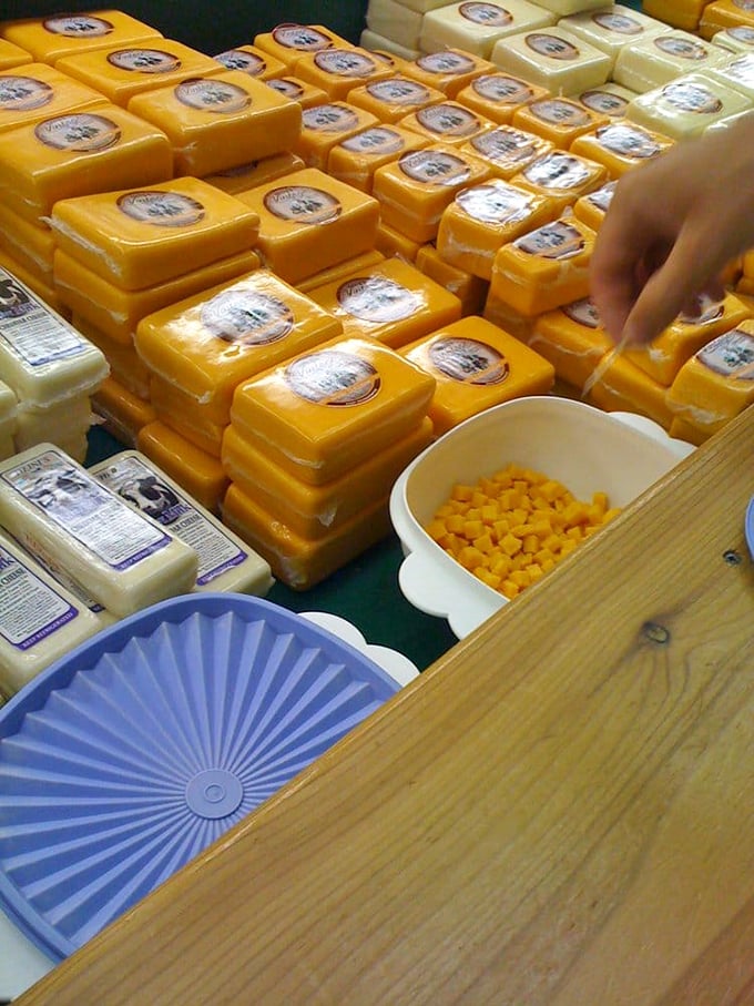 Blocks of golden cheddar stand in formation like a delicious army. That little sample bowl of cheese curds is calling your name.