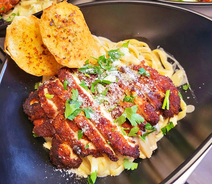 Pasta that's dressed better than most people at a wedding, with chicken that clearly got the memo about being the star of the show.