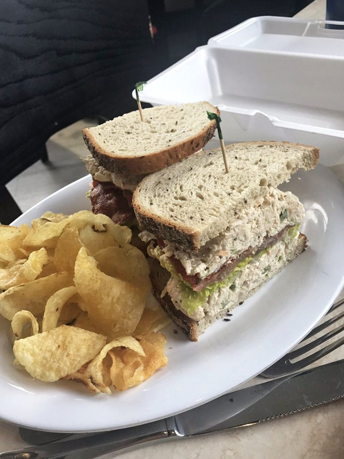 The club sandwich and chips—America's lunch diplomat, bringing together turkey, bacon, and veggies in a treaty of deliciousness.