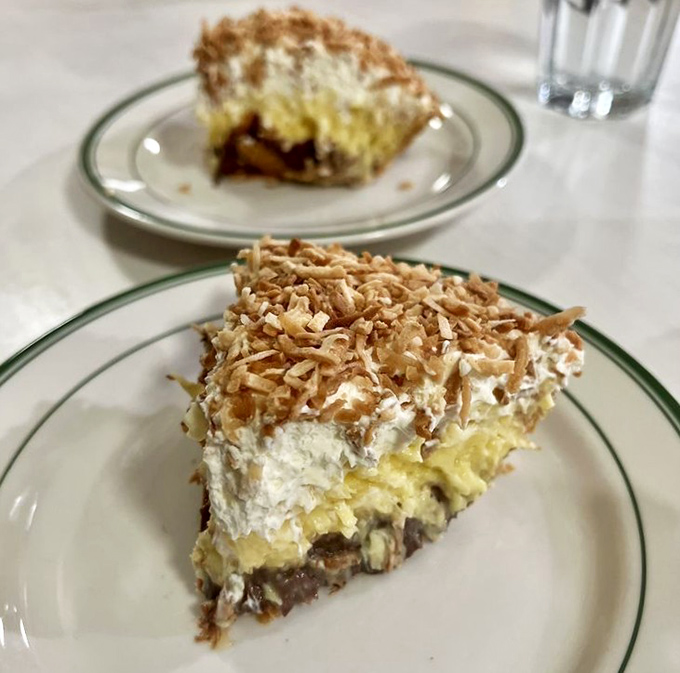 The coconut cream pie topped with toasted coconut flakes isn't trying to reinvent dessert &ndash; it's reminding you why classic desserts became classics in the first place.