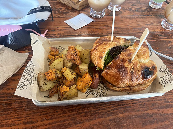 The croissant sandwich and roasted potatoes form a breakfast power couple that makes cereal at home seem like settling for a bad relationship.