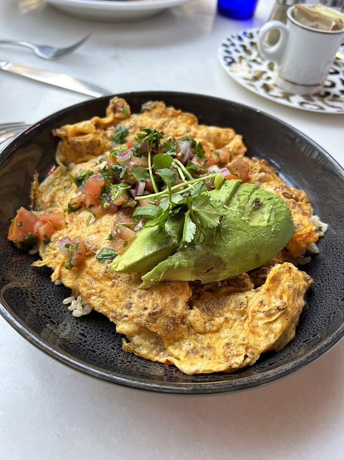 An omelet that refuses to be ordinary. Stuffed with savory goodness and topped with fresh avocado&mdash;breakfast with ambition.
