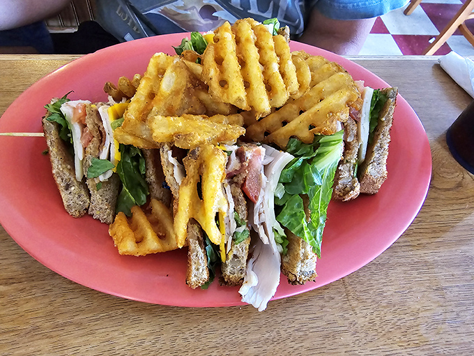 This club sandwich stands tall and proud, surrounded by a golden fortress of waffle fries&mdash;a lunch worth canceling afternoon plans for.