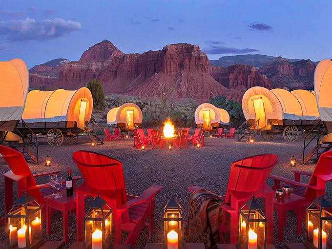 Conestoga wagons reimagined for the comfort-seeking pioneer. These glowing canvas shelters circle a campfire like a scene from the most luxurious Oregon Trail ever.