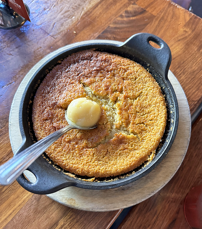 Cornbread skillet with a pat of butter melting into golden perfection. Southern tradition served piping hot with a side of nostalgia.