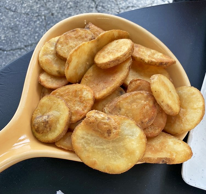 These aren't just potatoes; they're golden discs of comfort that have achieved the perfect crispness-to-fluffiness ratio. Diet plans tremble in their presence.