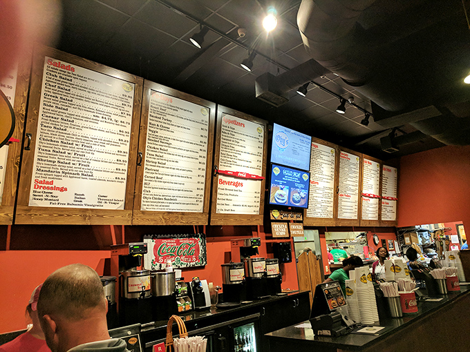 Where sandwich dreams begin: the counter where friendly faces transform orders into edible works of art.