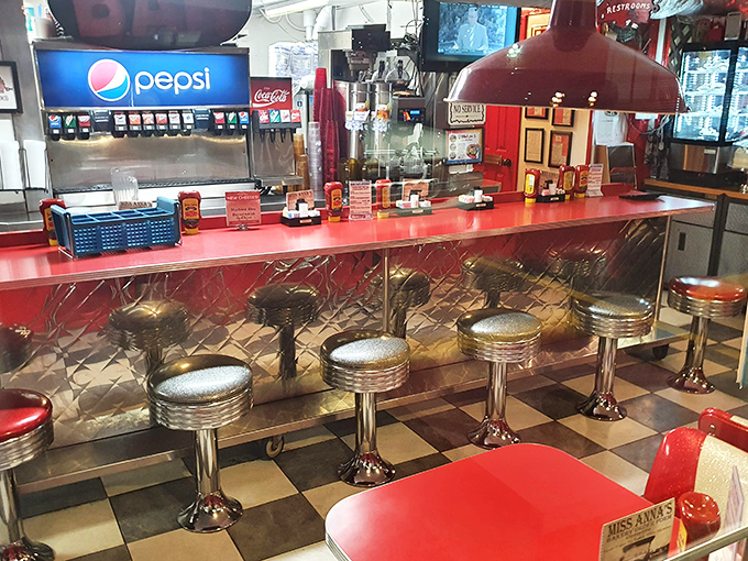 The counter where magic happens: chrome stools, red laminate, and soda fountains that have witnessed first dates, family celebrations, and everyday hunger satisfaction.