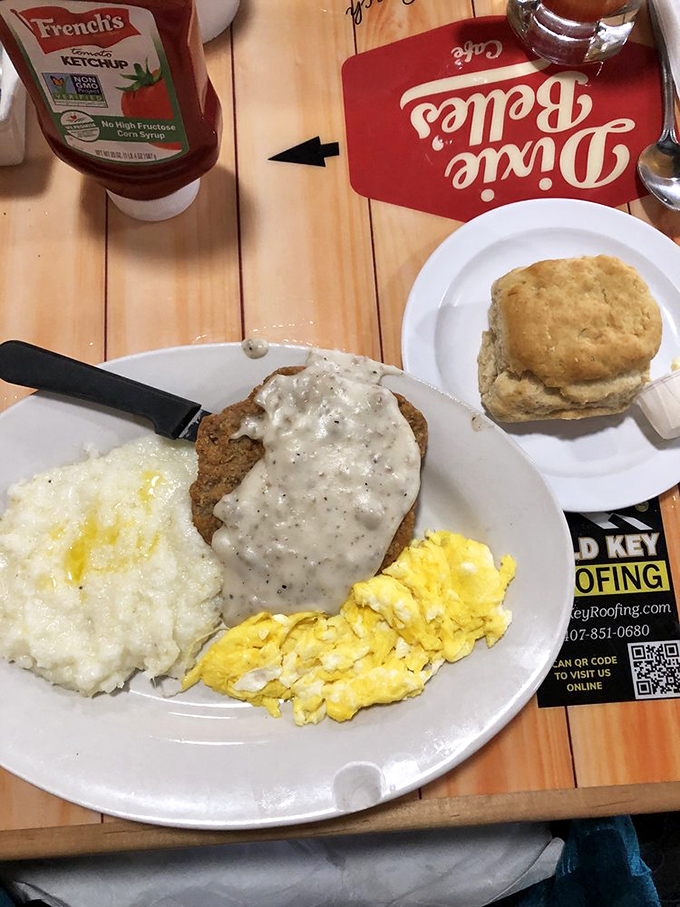 The holy trinity of Southern breakfast: country fried steak, fluffy eggs, and a biscuit standing by. Not pictured: your willpower disappearing.