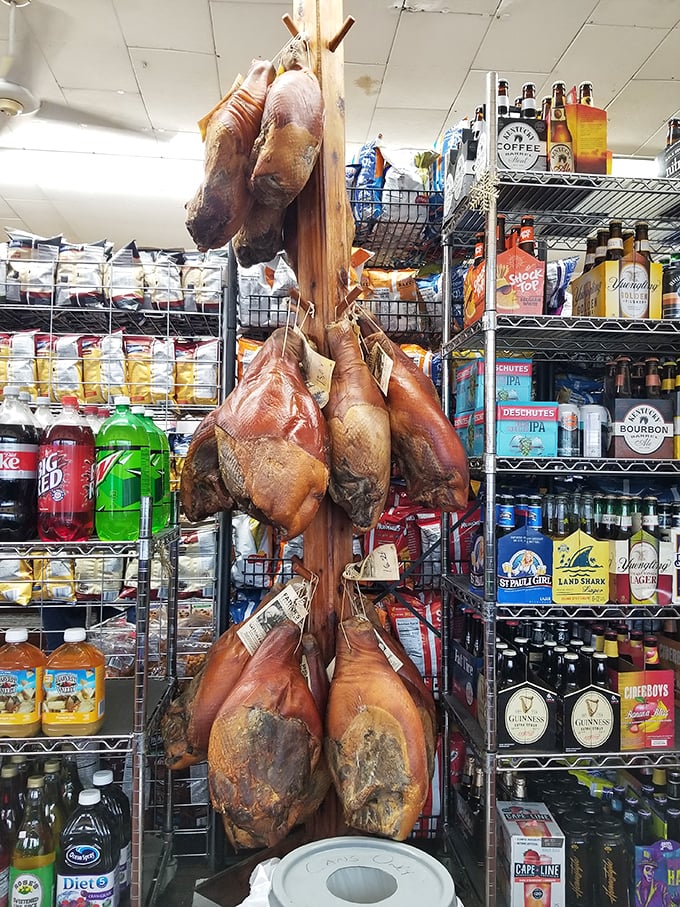 Country hams hanging like meaty stalactites in a cave of deliciousness. Kentucky's traditional cure for hunger in its natural habitat.