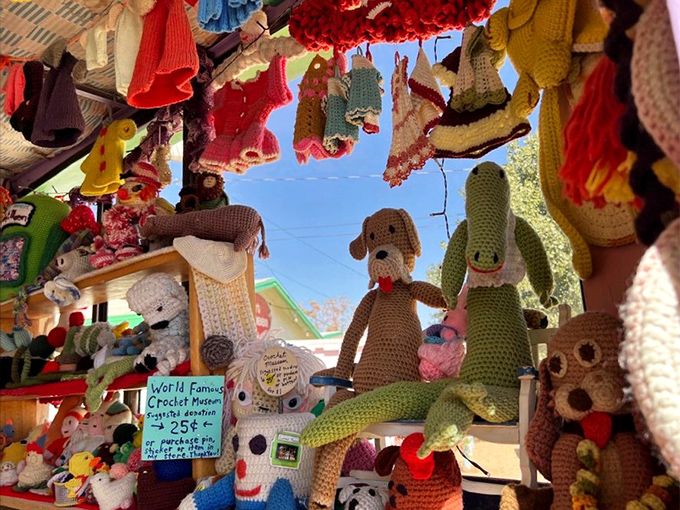 Crocheted creatures dangle overhead like a whimsical mobile designed by someone with serious yarn obsession and talent. 