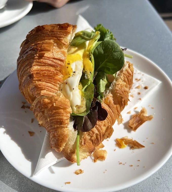 A croissant sandwich that makes lunch feel like a celebration. Those flaky layers should come with a warning: "Prepare for delicious mess."