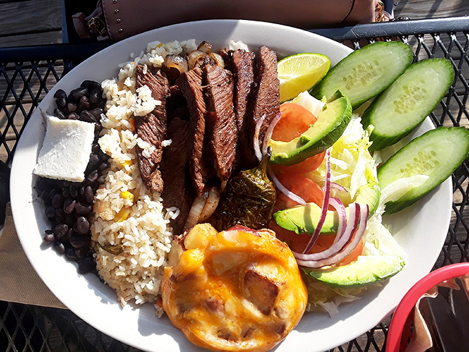 This plate doesn't just serve food&mdash;it serves a masterclass in balance with perfectly grilled steak, rice, beans, and fresh vegetables.
