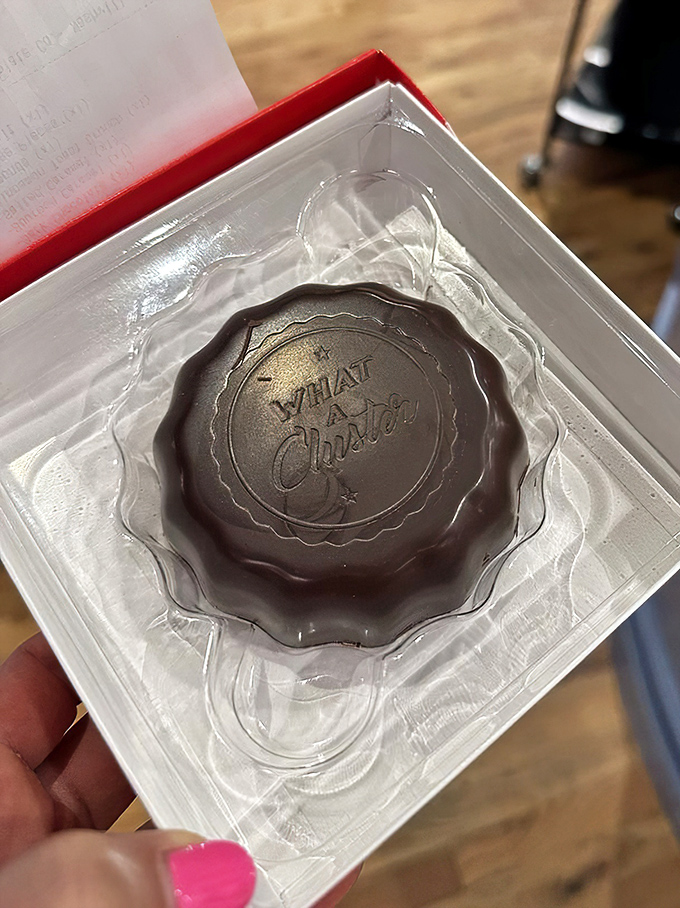 This dark chocolate masterpiece sits in its clear throne like royalty, the embossed "What A Cluster" both a name and an accurate description.