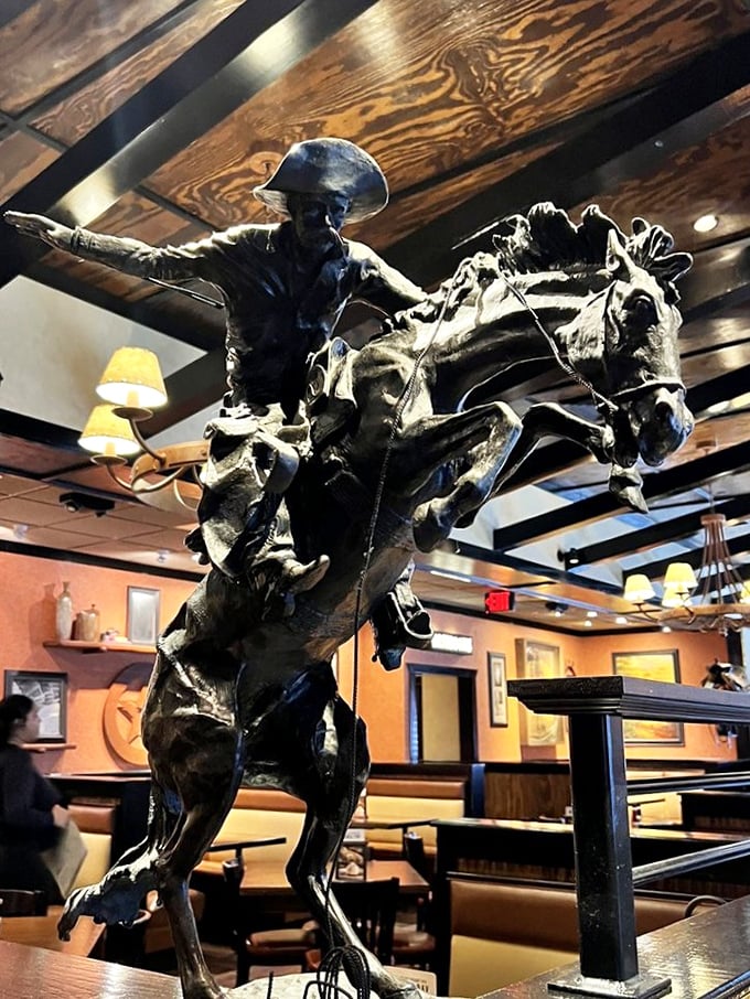 The dramatic cowboy sculpture captures the Western spirit, frozen mid-gallop above diners. It's theatrical without crossing into theme park territory.