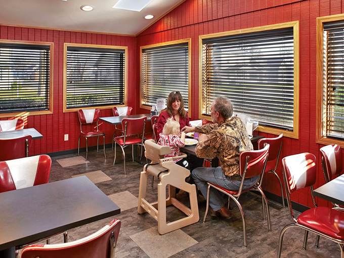 Red booths and chrome chairs create that classic diner atmosphere where conversations flow as freely as the coffee refills.