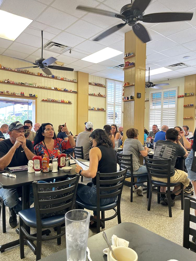 A packed house of happy diners surrounded by the restaurant's signature shaker collection. The breakfast buzz is real, and it's not just from the coffee.